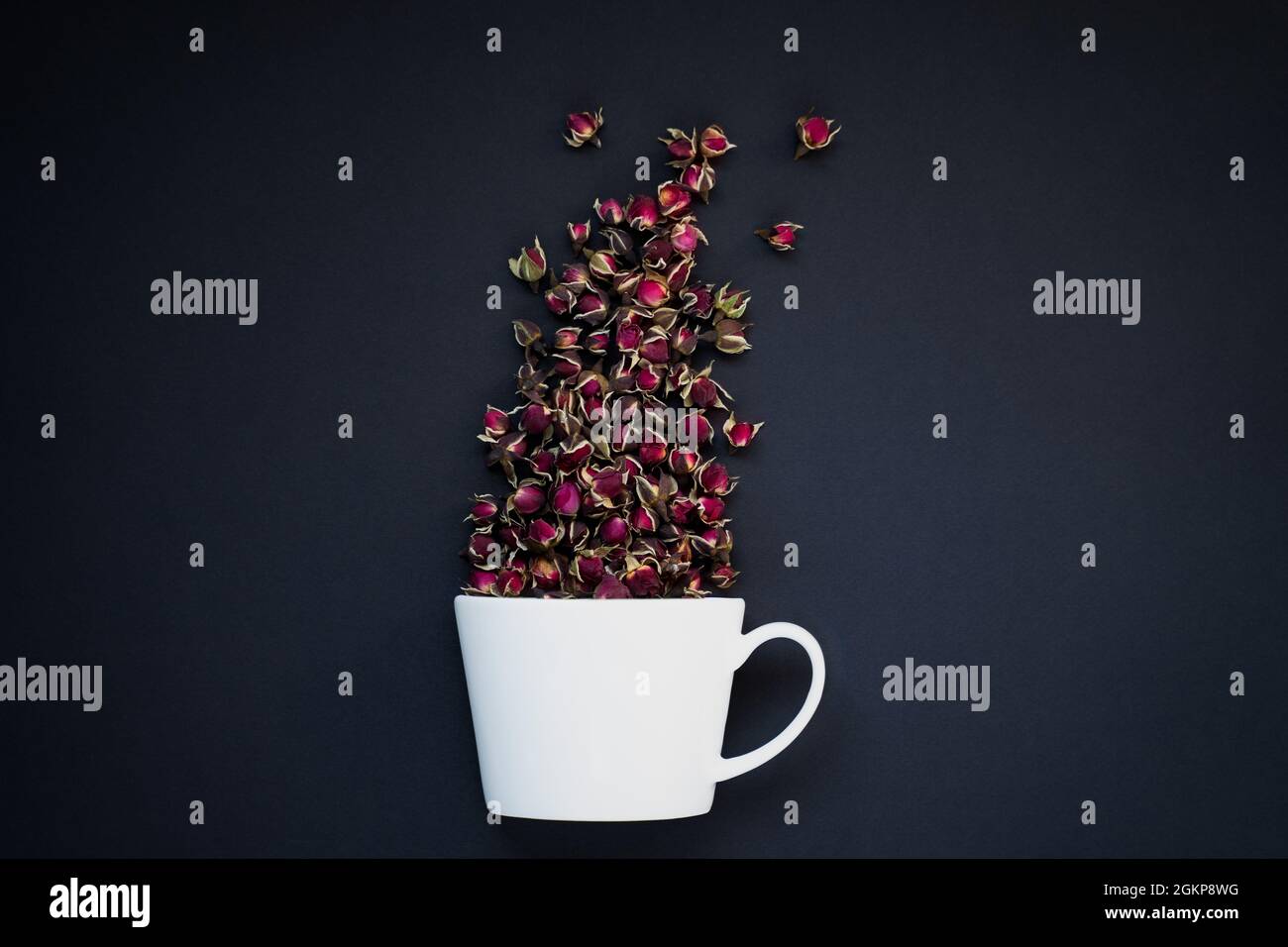 Blank white ceramic mug on black background with rosebuds exploding out ...