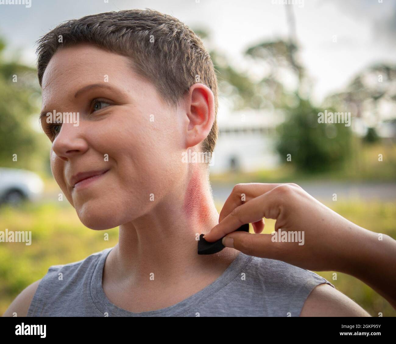 An Airman gets makeup applied to her neck to show rash and bruising ...