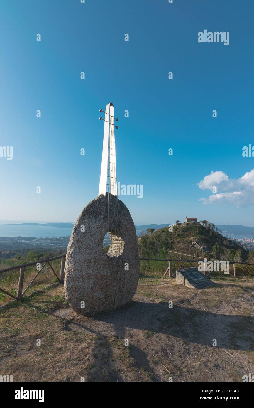 Guitar-shaped stone sculpture Stock Photo - Alamy