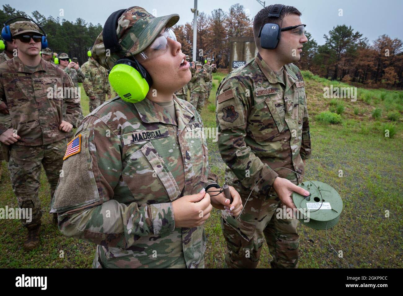 U.S. Army Staff Sgt. Tricia C. Madrigal, center, assistant operations ...