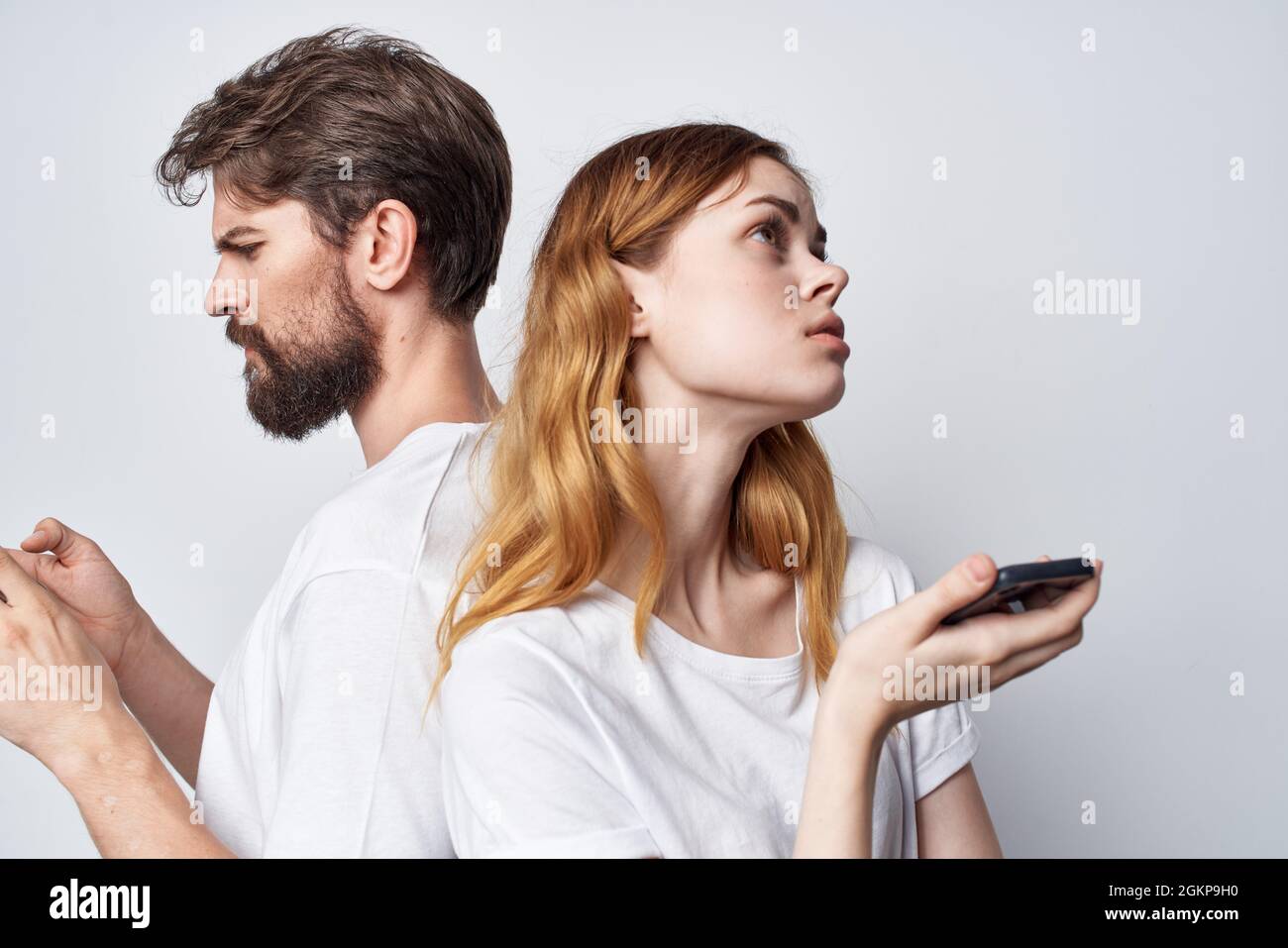 a young couple quarrel jealousy telephones communication light ...