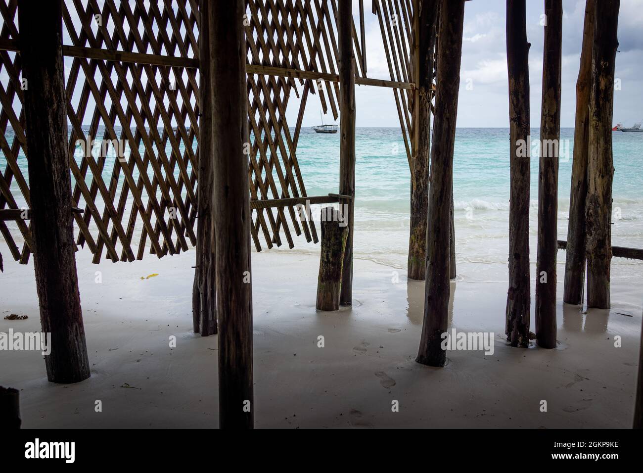 Wooden pillars on ocean shore into blue water with no people Stock ...