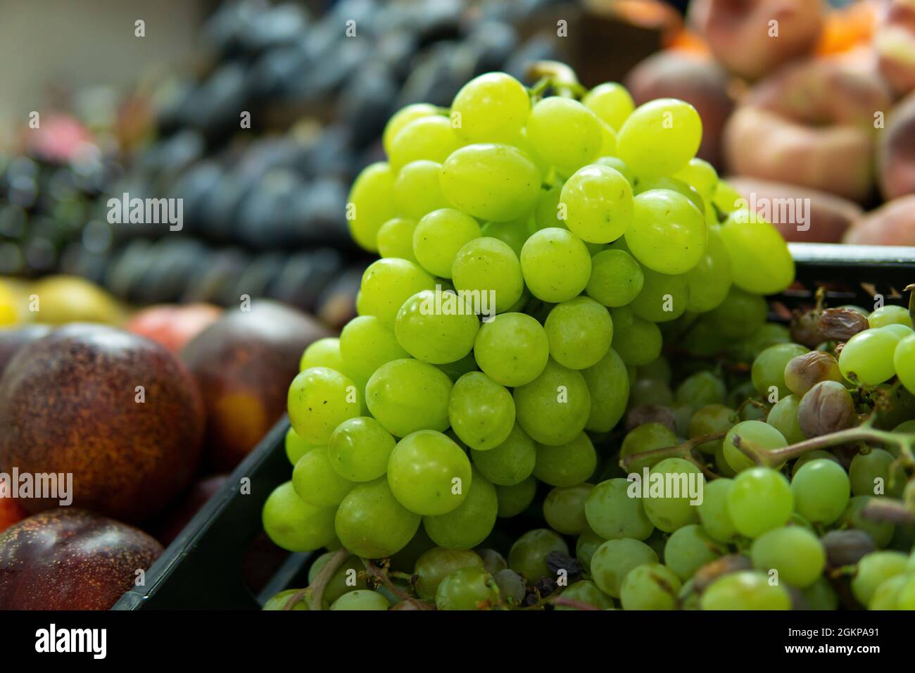 Cluster of fresh green grapes on display at a traditional food m Stock ...