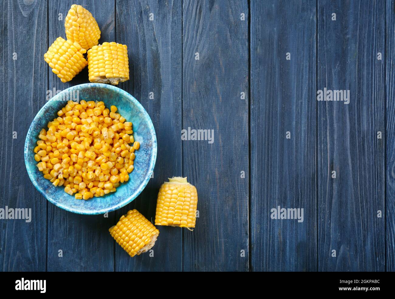 Corn kernels and cut cob on wooden background Stock Photo - Alamy