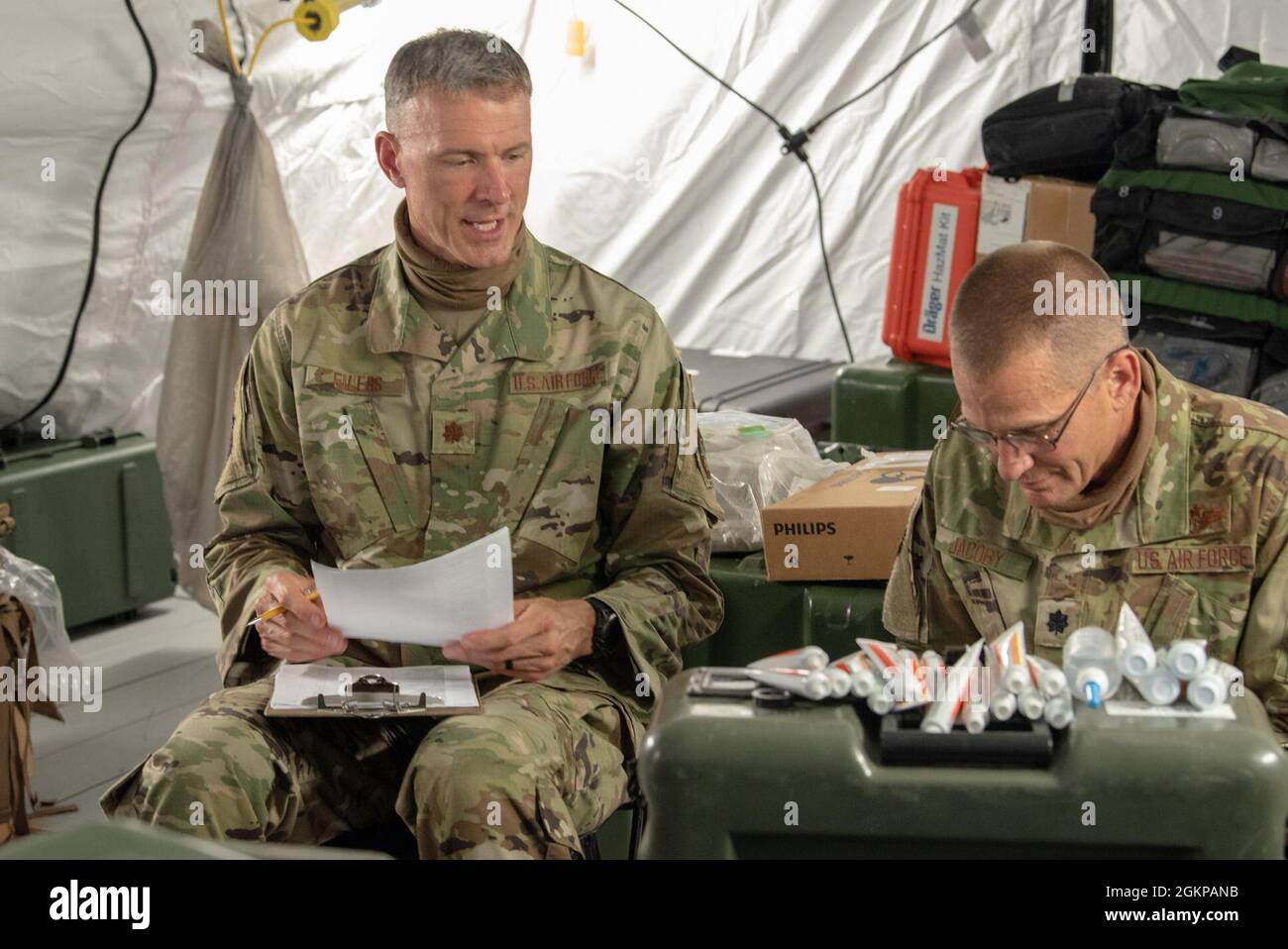 Maj. Kevin Eilers (left) assists Lt. Col. Darin Jacoby, 123rd ...