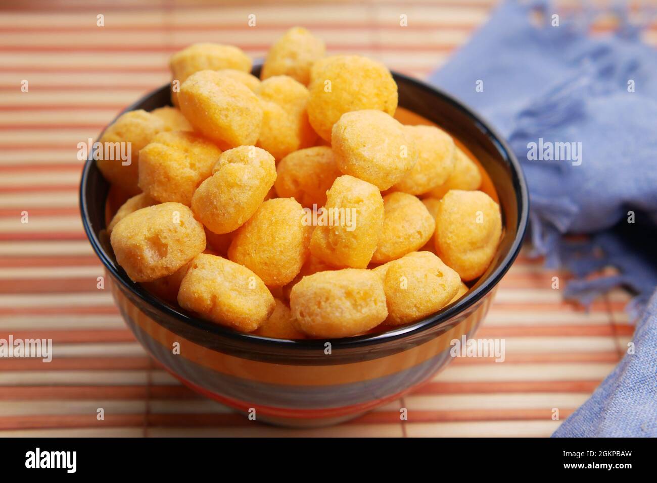 puffed corn rings chips in black bowl on white background Stock Photo ...