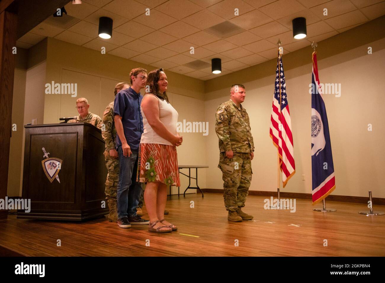 Chief Warrant Officer 3 Bryan Woodward’s family waits on stage to pin ...