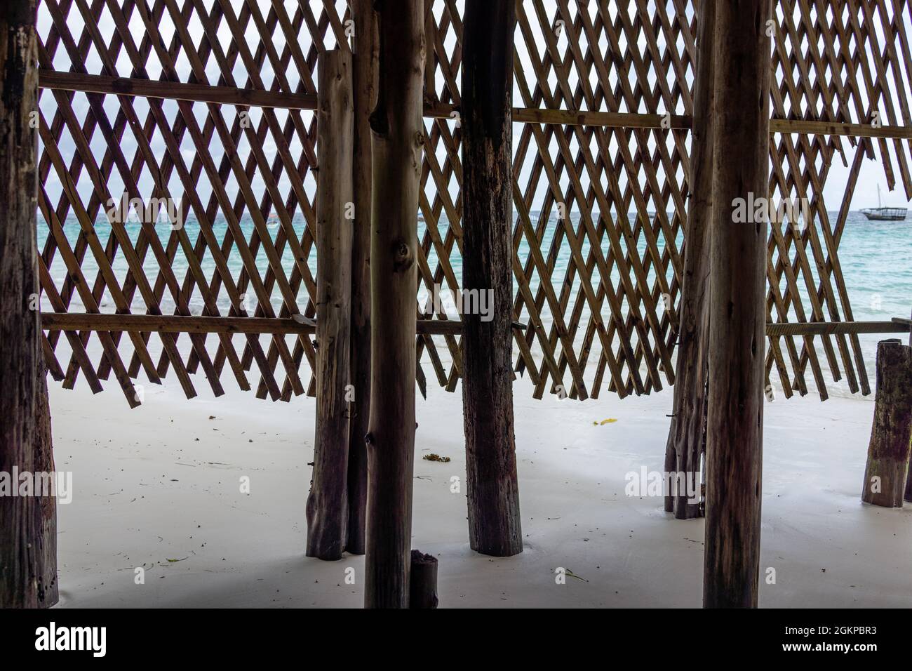 Wooden pillars on ocean shore into blue water with no people Stock ...