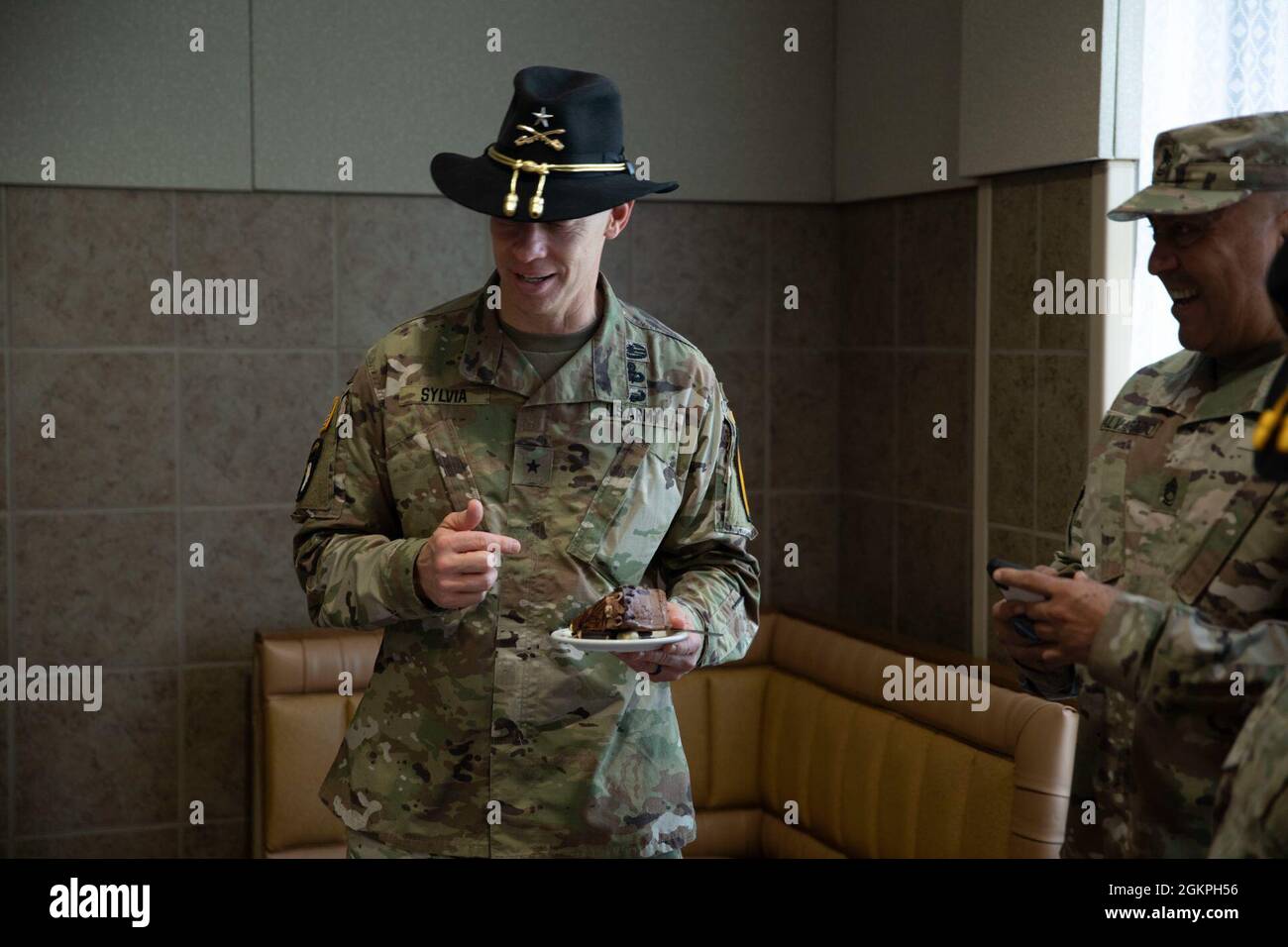 Brig. Gen. Brett Sylvia conducts a taste test of one of the cakes ...