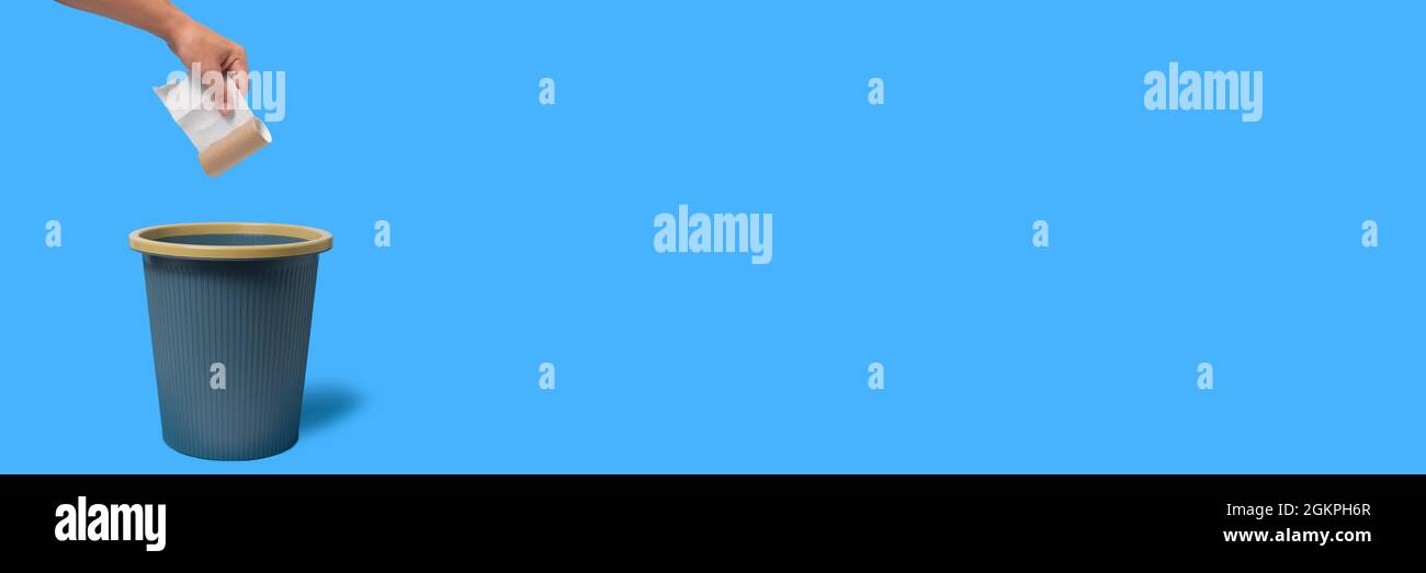 Banner,spent roll of toilet paper thrown into trash, on a blue ...