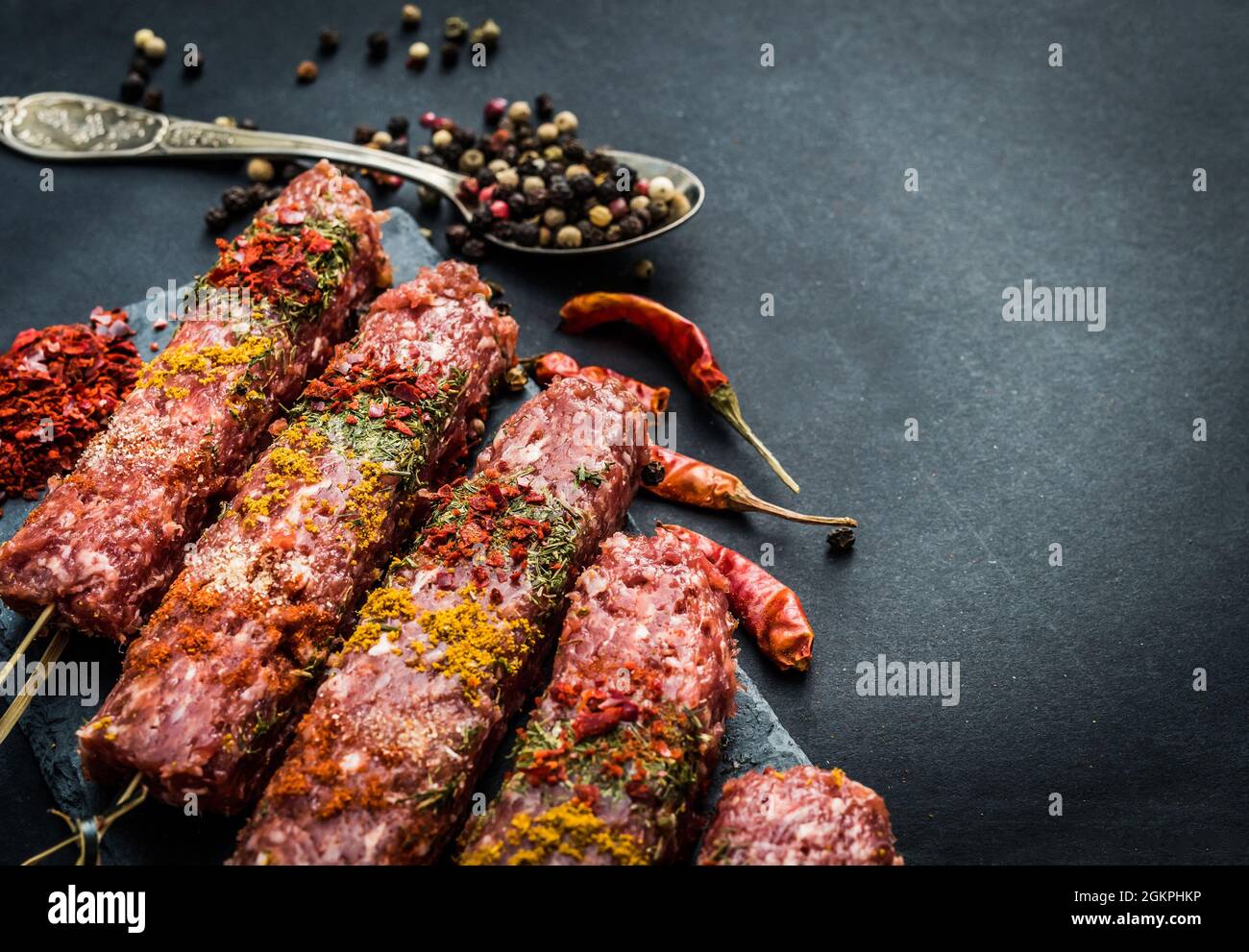 Raw kebab with spices Stock Photo - Alamy