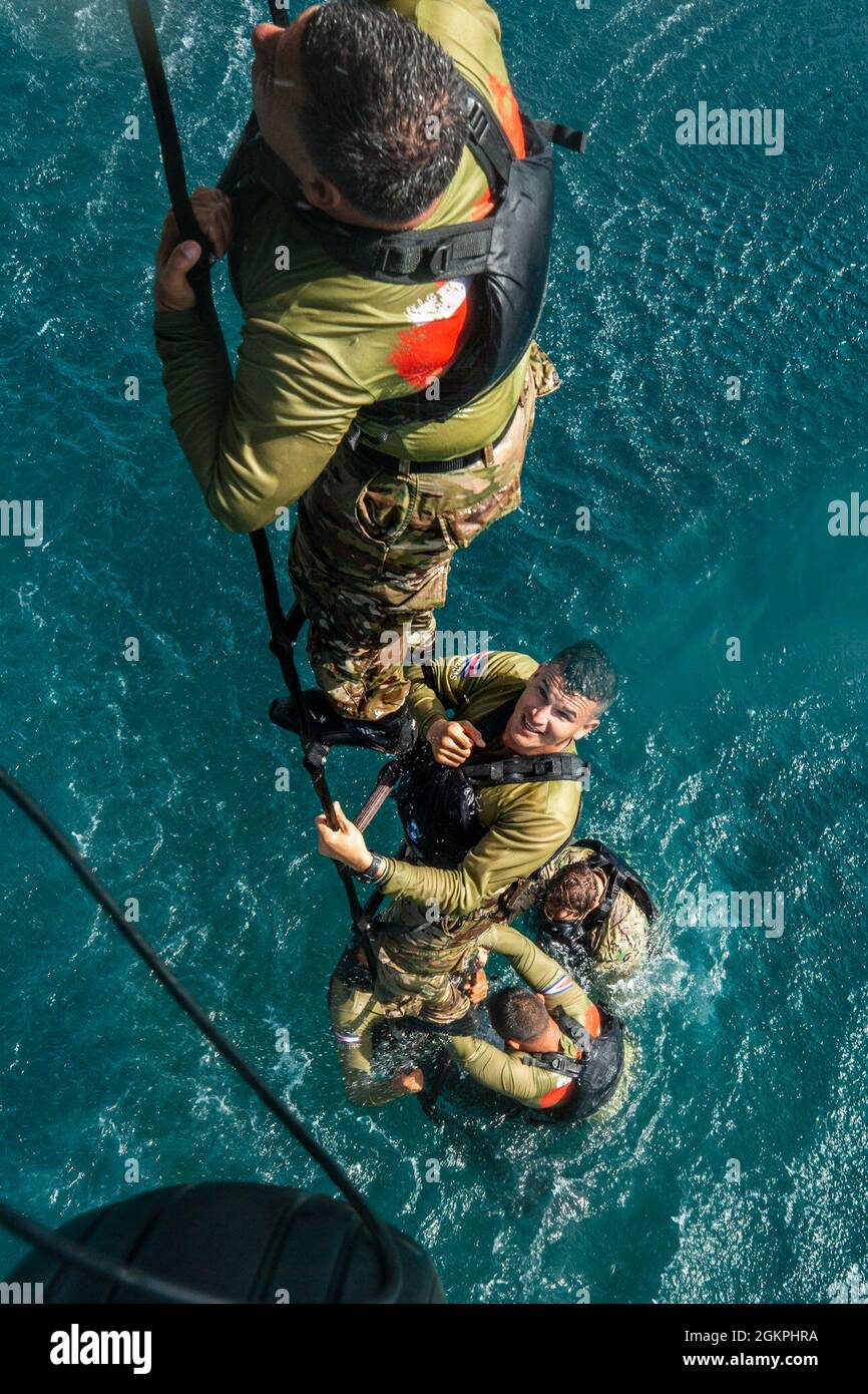 Costa Rican policemen with the Costa Rican police forces climb up a ...