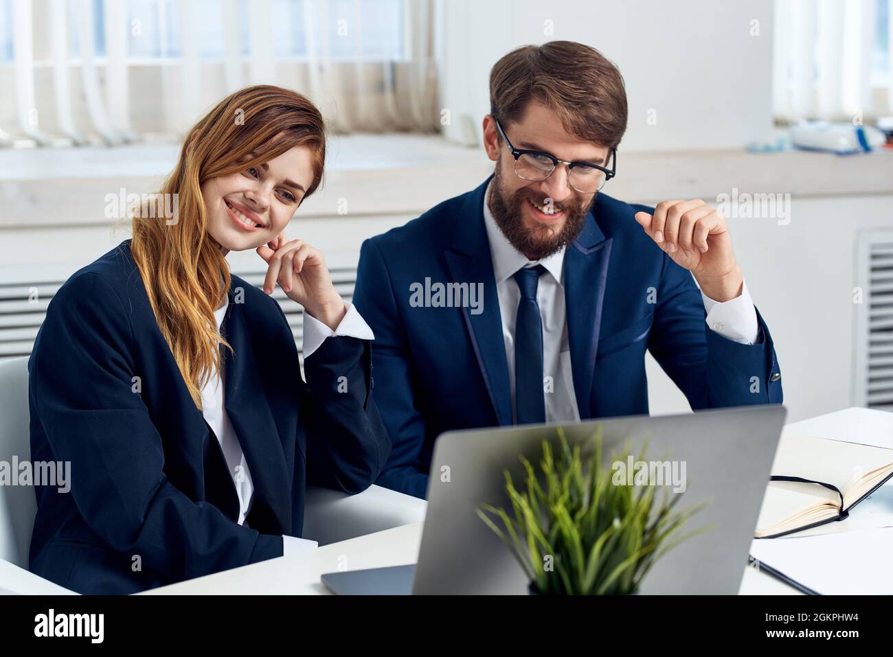 business man and woman work together in front of laptop professionals ...