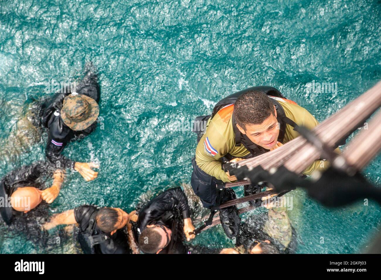 Costa Rican policemen with the Costa Rican police forces climb up a ...