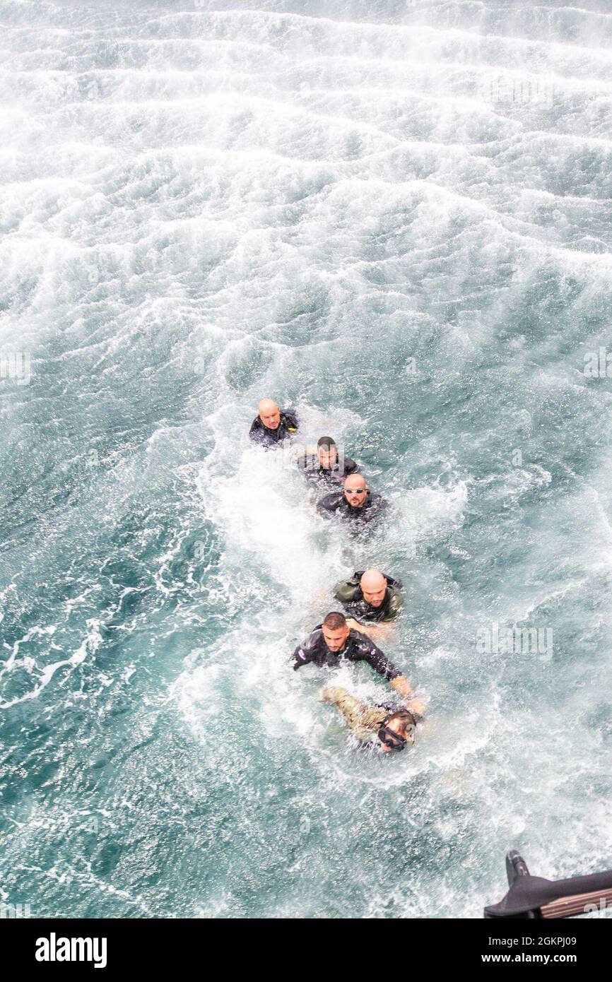 Costa Rican policemen with the Costa Rican police forces swim to a ...