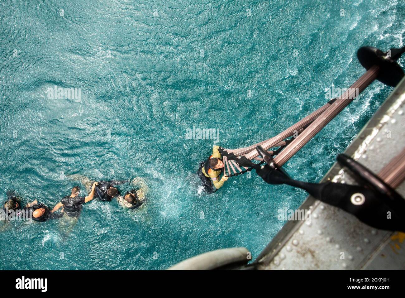 Costa Rican policemen with the Costa Rican police forces climb up a ...