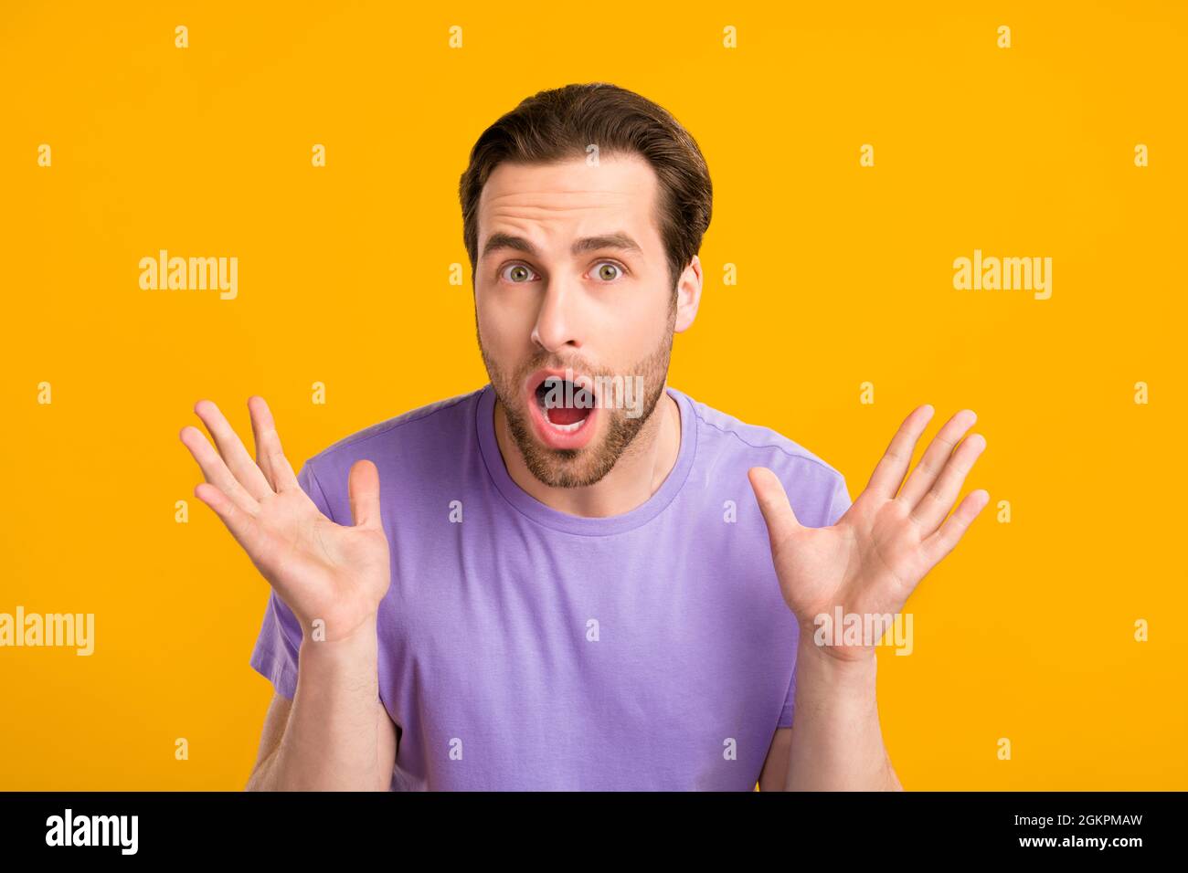 Photo of speechless shocked guy raise hands omg reaction wear purple t ...