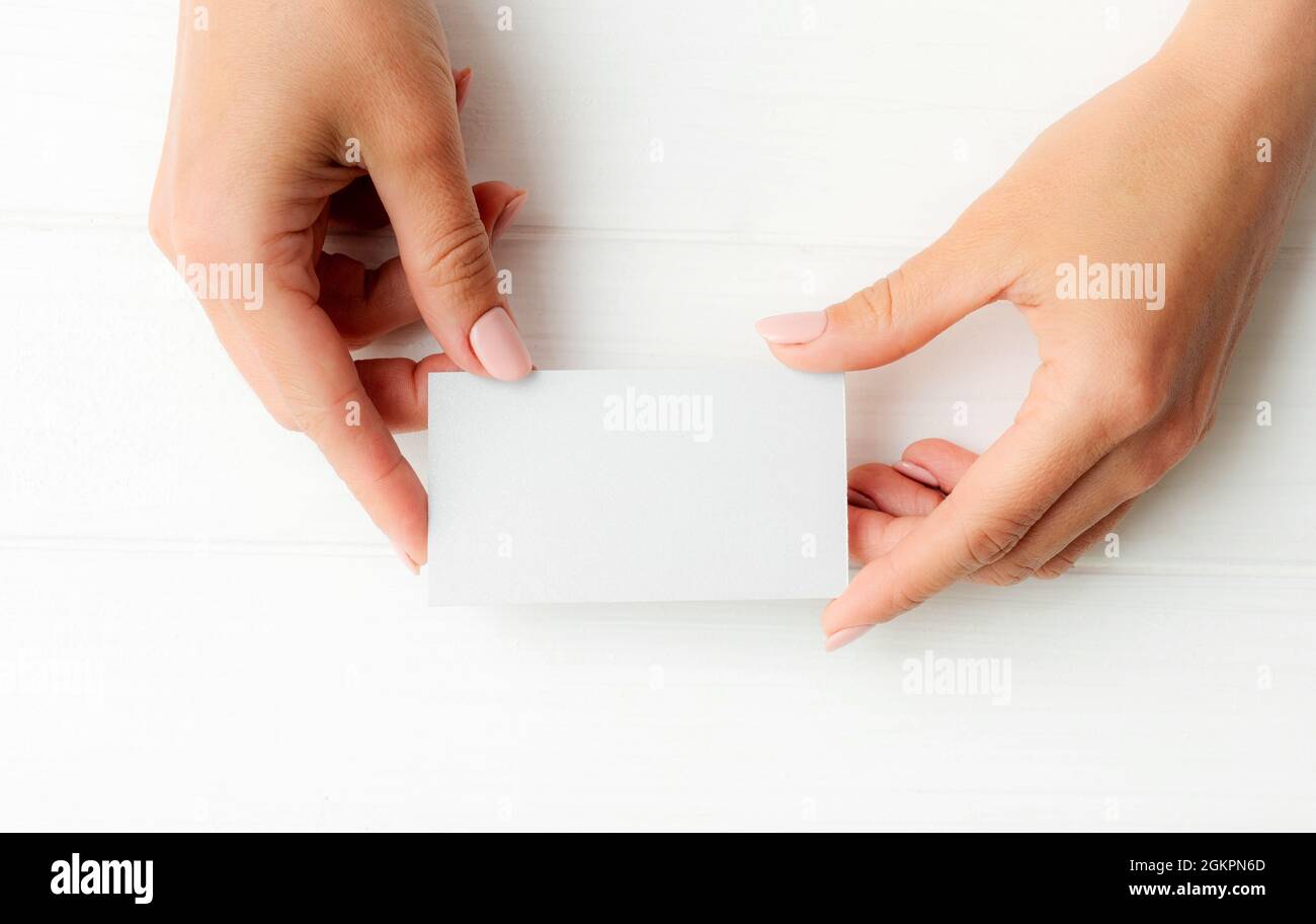 White business card in girl hands Stock Photo - Alamy