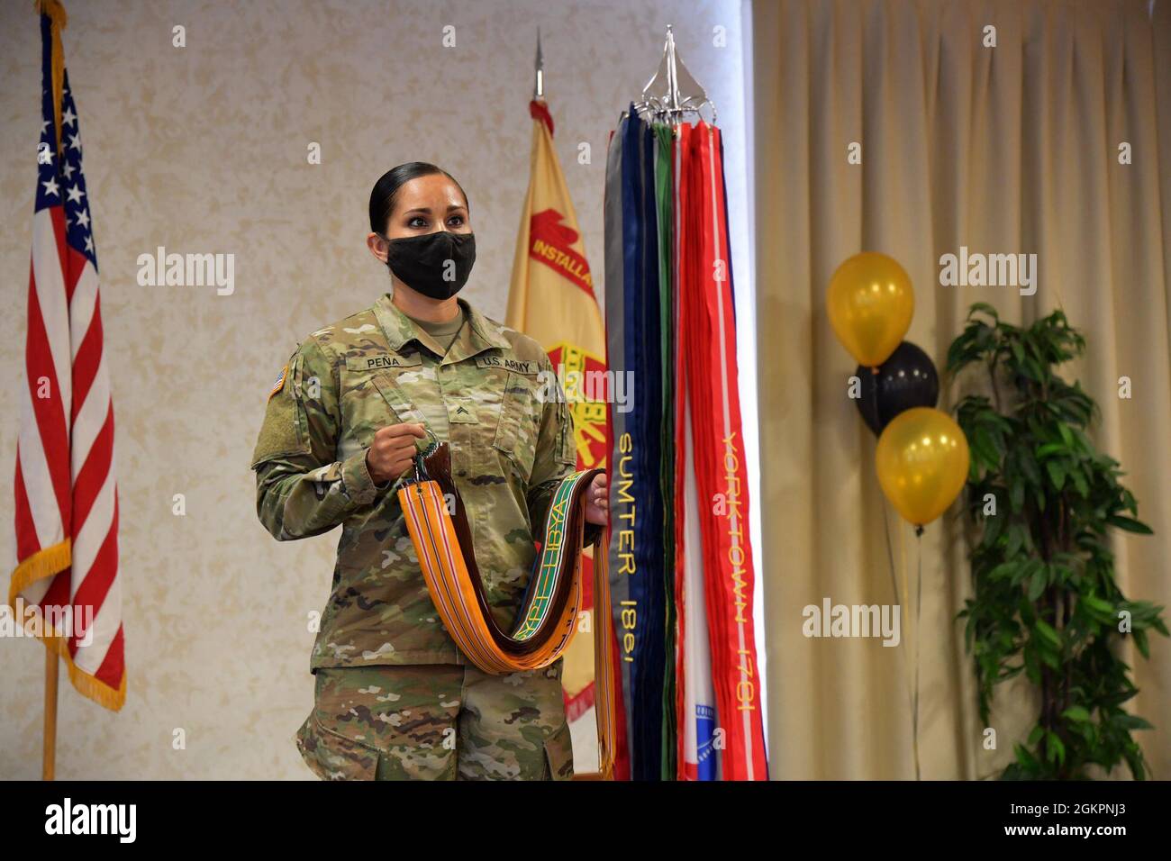 A U.S. Army Soldier place Army battle streamers representing historic ...