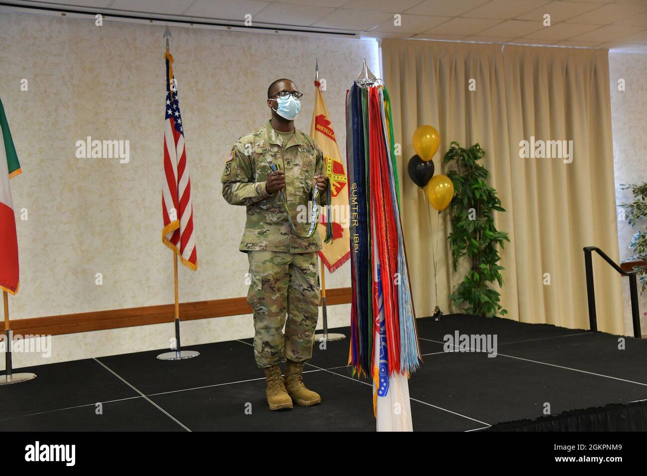 A U.S. Army Soldier place Army battle streamers representing historic ...