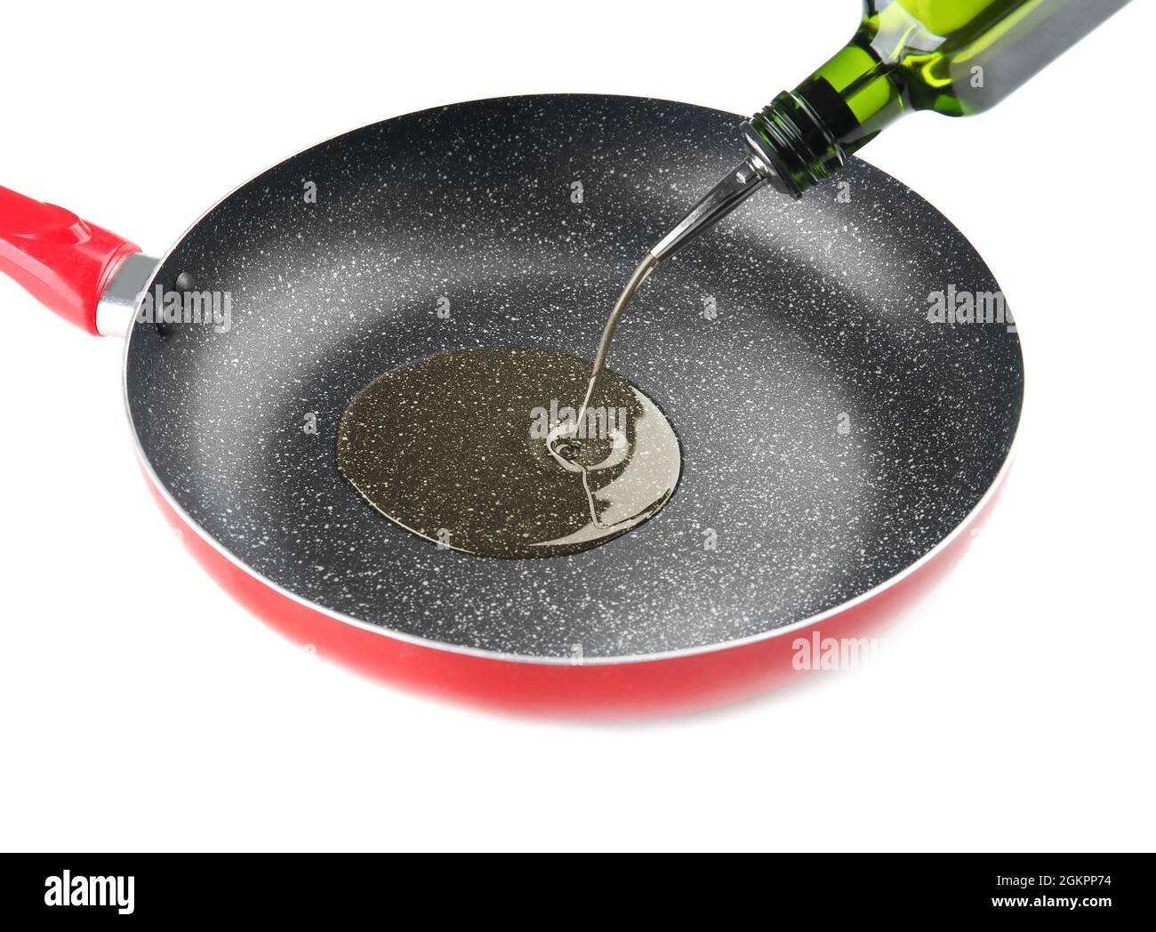 Pouring oil into frying pan on white background Stock Photo - Alamy