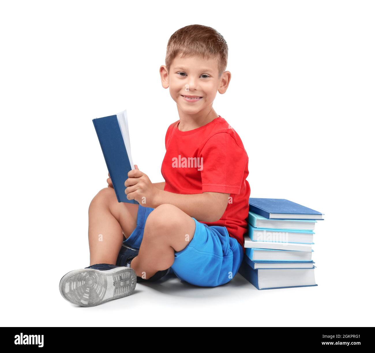 Cute little boy reading books on white background Stock Photo - Alamy