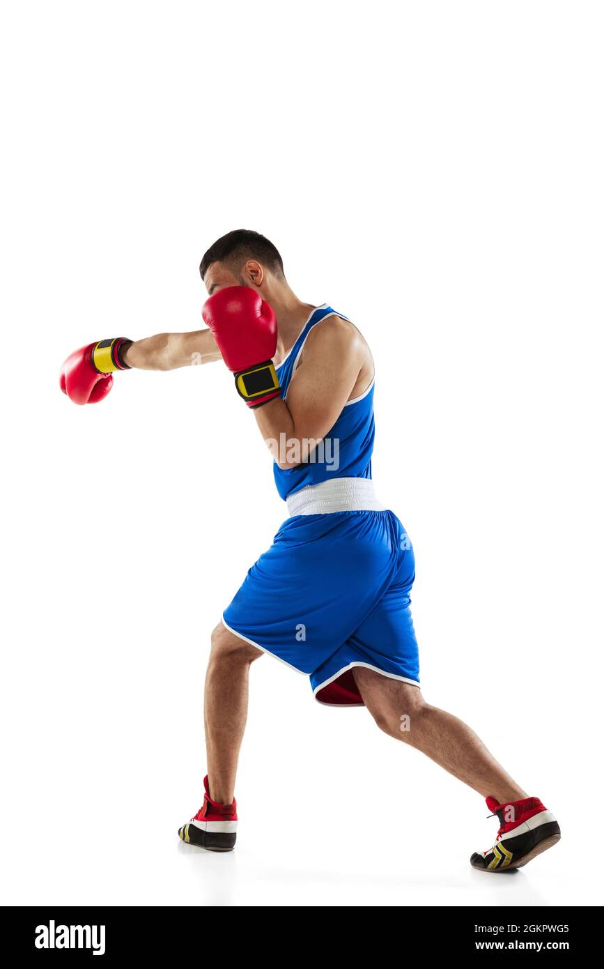 Strong fists. One professional boxer in blue uniform training isolated ...