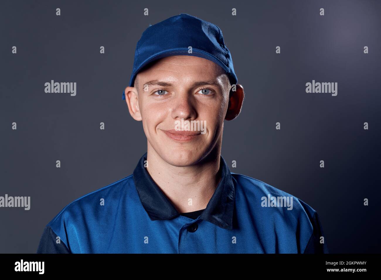 man in work uniform blue cap close-up of service Stock Photo - Alamy