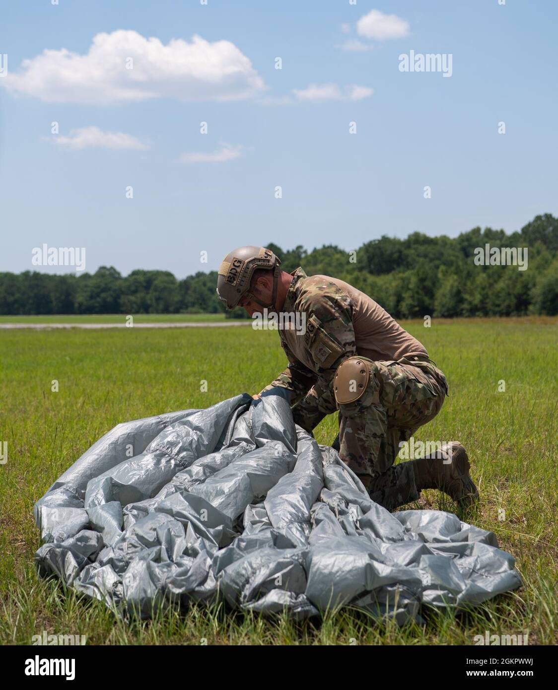 An Airman from the 820th Base Defense Group repacks his parachute after ...