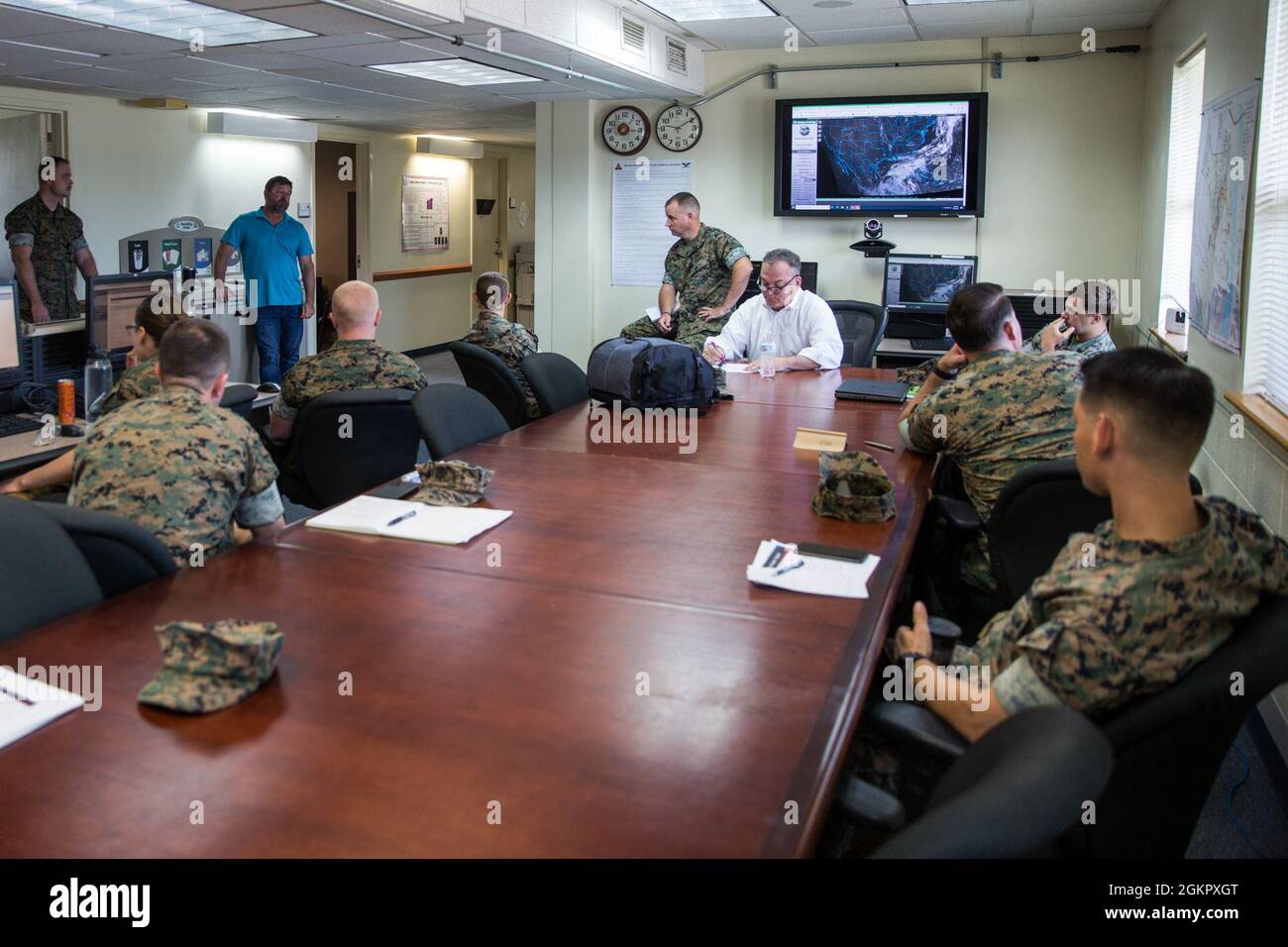 U.S. Marines and civilians discuss plans at the Emergency Operations ...