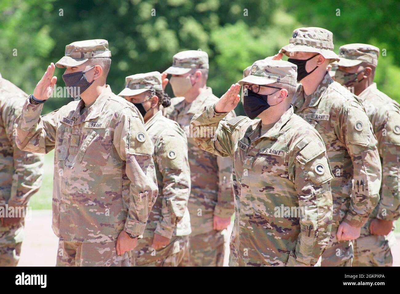 Soldiers of the 1st Theater Sustainment Command salute the flag during ...