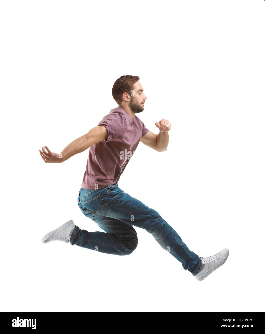 Young man in casual clothes running on white background Stock Photo - Alamy