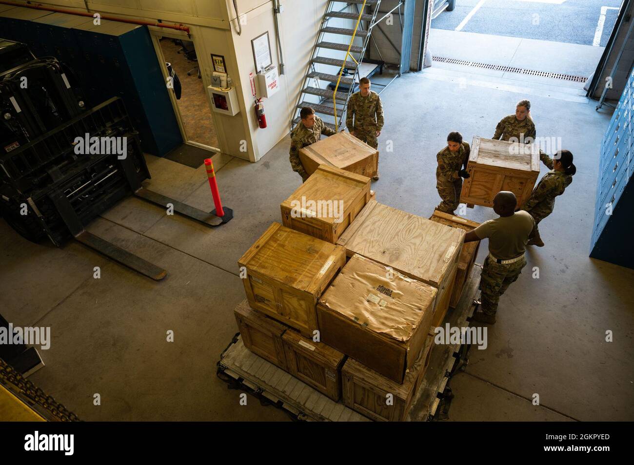 Airmen assigned to the 32nd Aerial Port Squadron build up a cargo ...