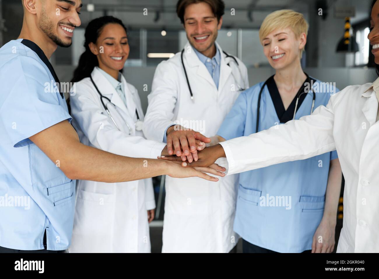 Positive multiethnic team of doctors cheering up each other Stock Photo ...