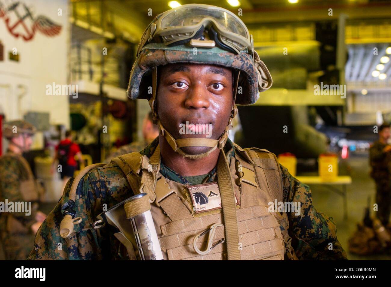 U.S. Marine Corps Lance Cpl. Hassan-Thomas Jones, an assistant machine ...