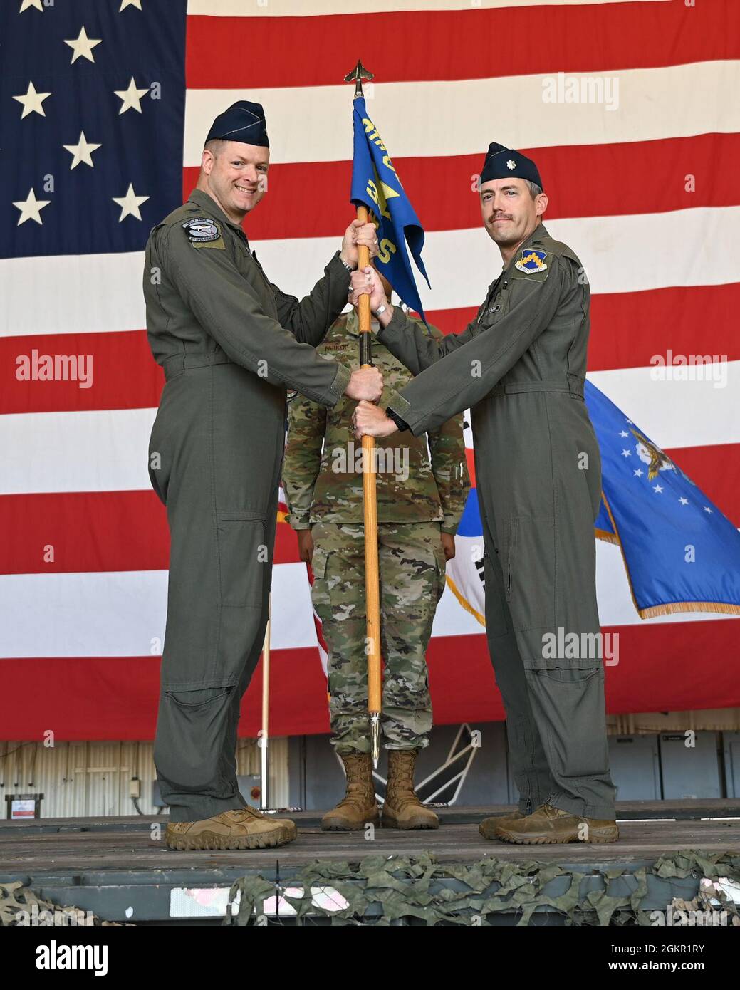 Col. Lynn Savage, 8th Operations Group commander, presents the ceremonial guidon to Lt. Col ...