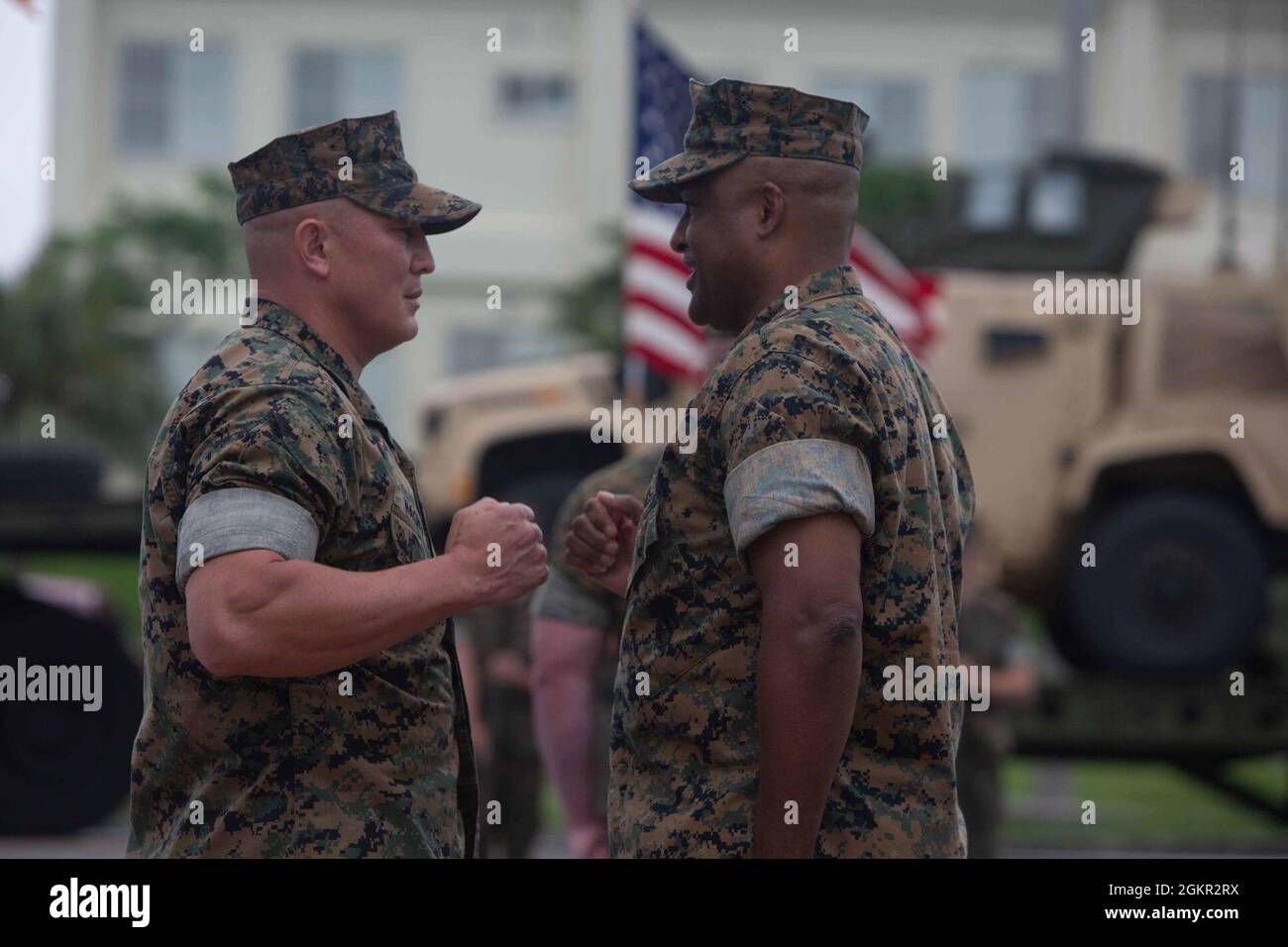 U.S. Marine Corps Lt. Col. Douglas J. Cobb, right, gives a fist bump to ...