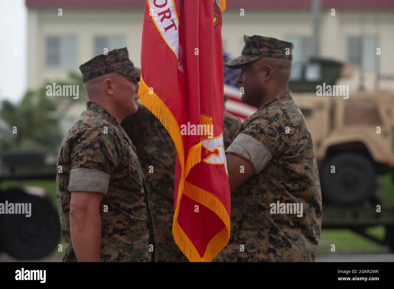 U.S. Marine Corps Lt. Col. Douglas J. Cobb, right, passes the colors to ...
