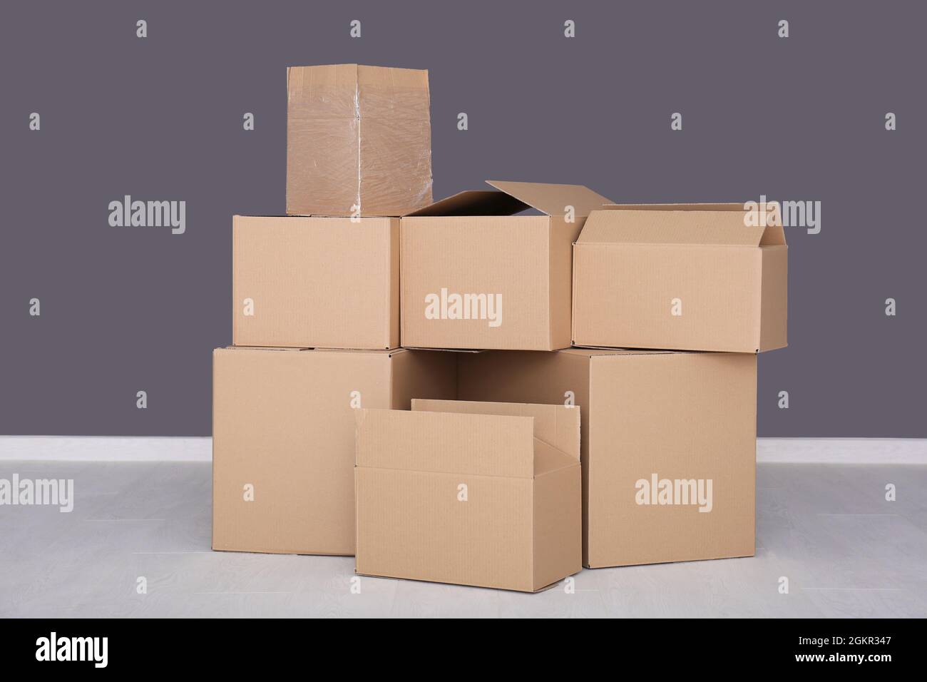 Office move concept. Carton boxes on floor in empty room Stock Photo ...