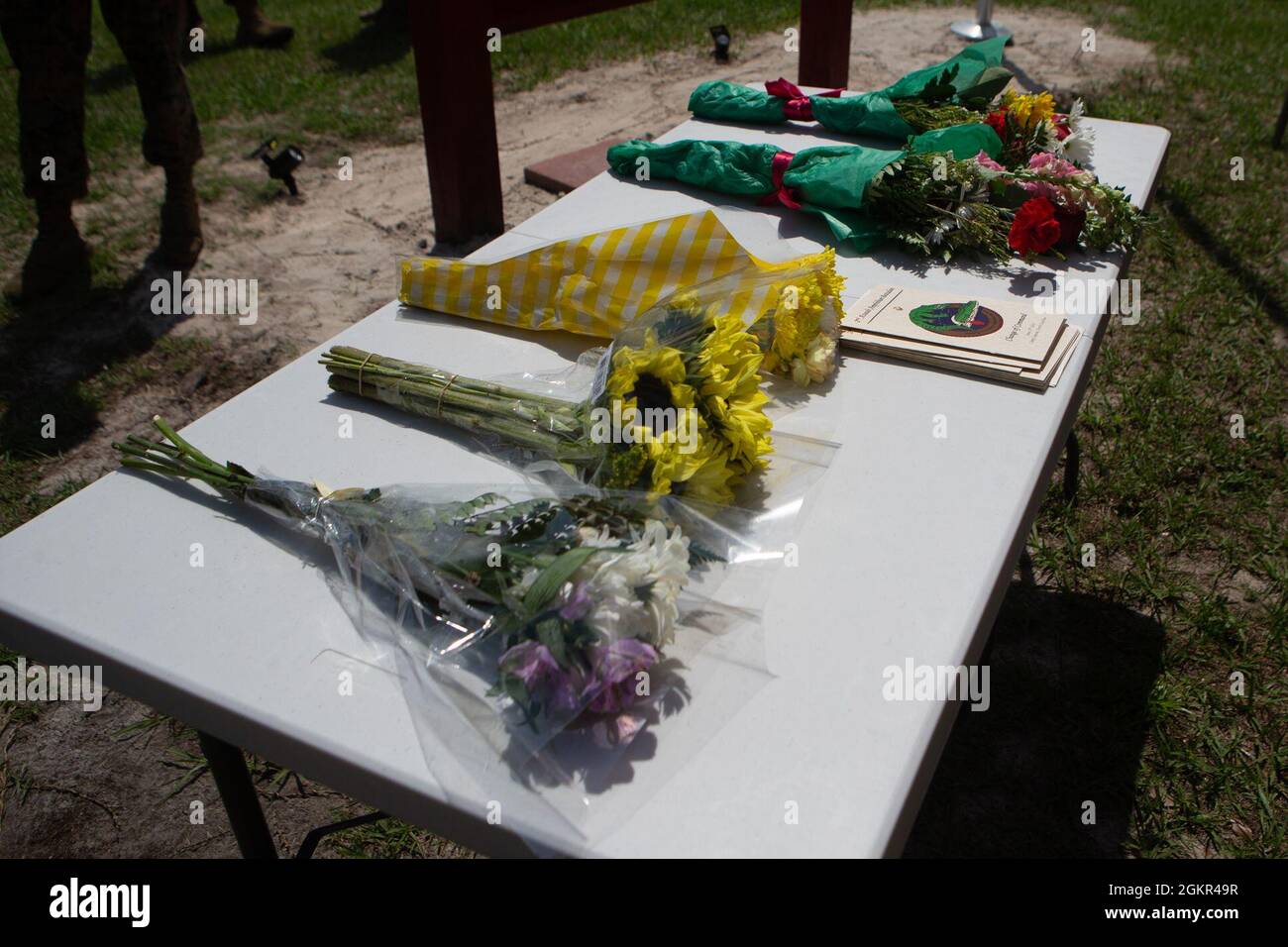 Flowers for family members rest on a table during a change of command ...