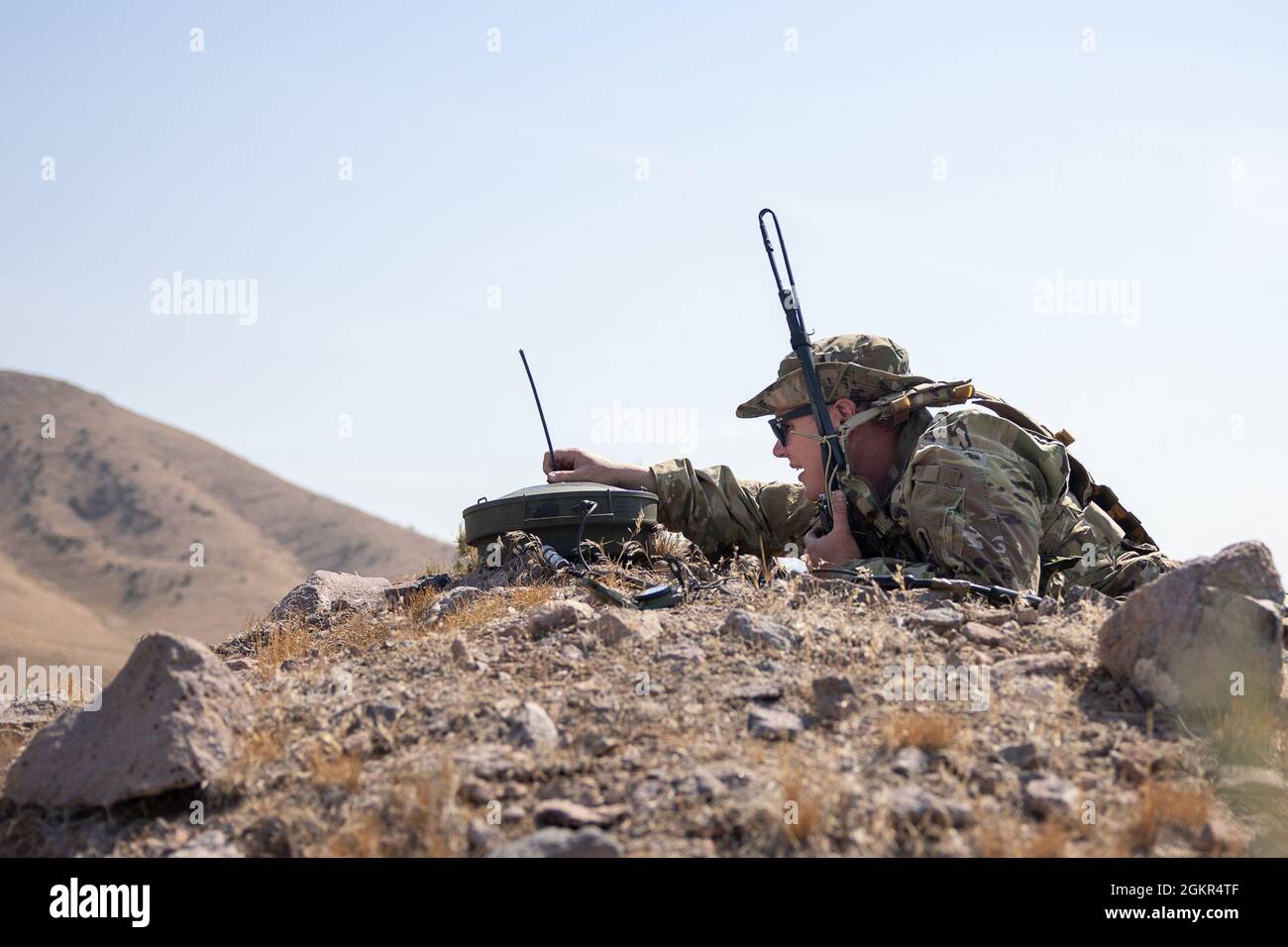A soldier prepares a low level audio interception device on top of a ...