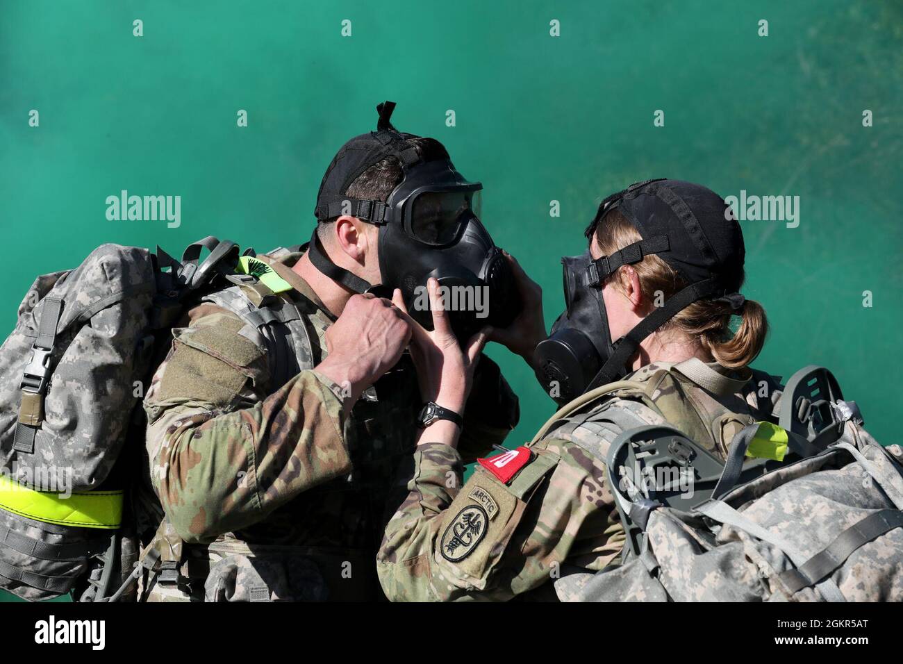 Capt. Laura Benz, right, helps Spc. Colin Hoffmann with his protective ...