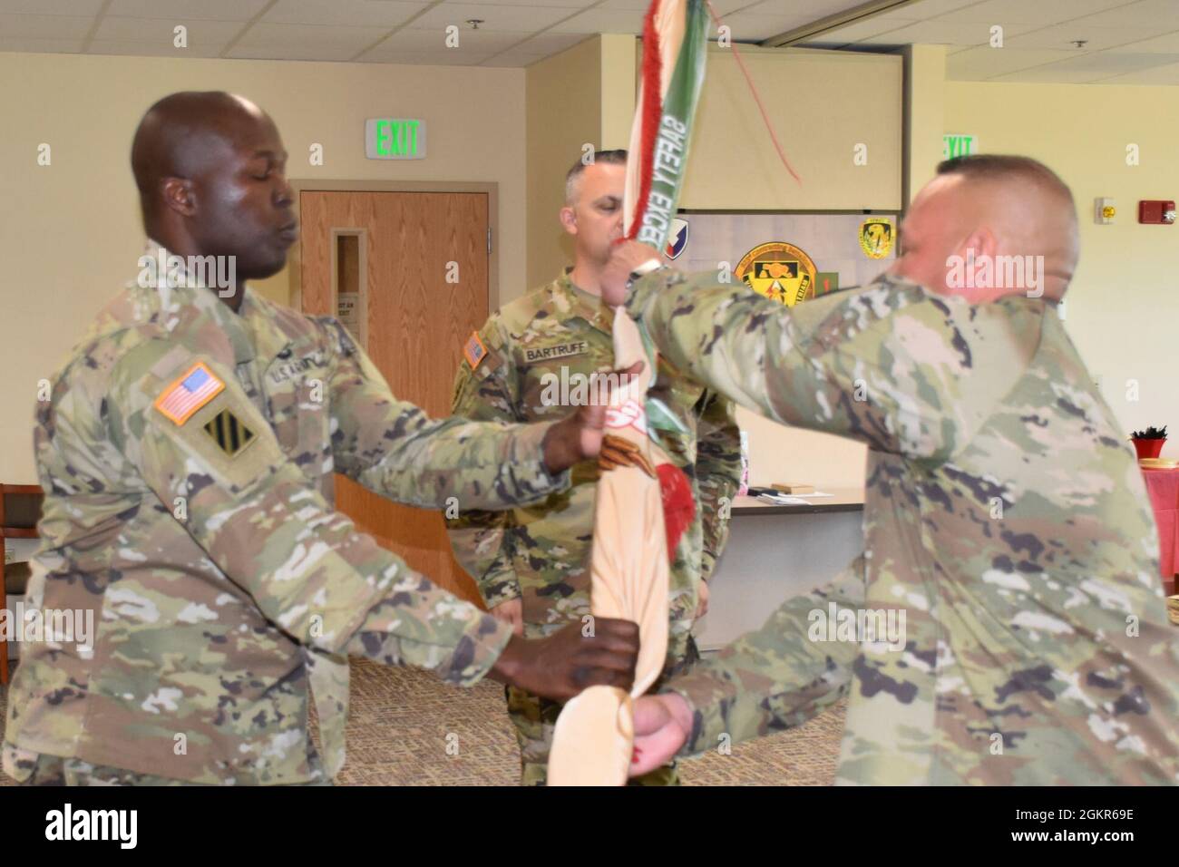 Lt. Col. Randy Garcia, passes the colors of the 923rd Contracting Battalion to Master Sgt. Shaun ...