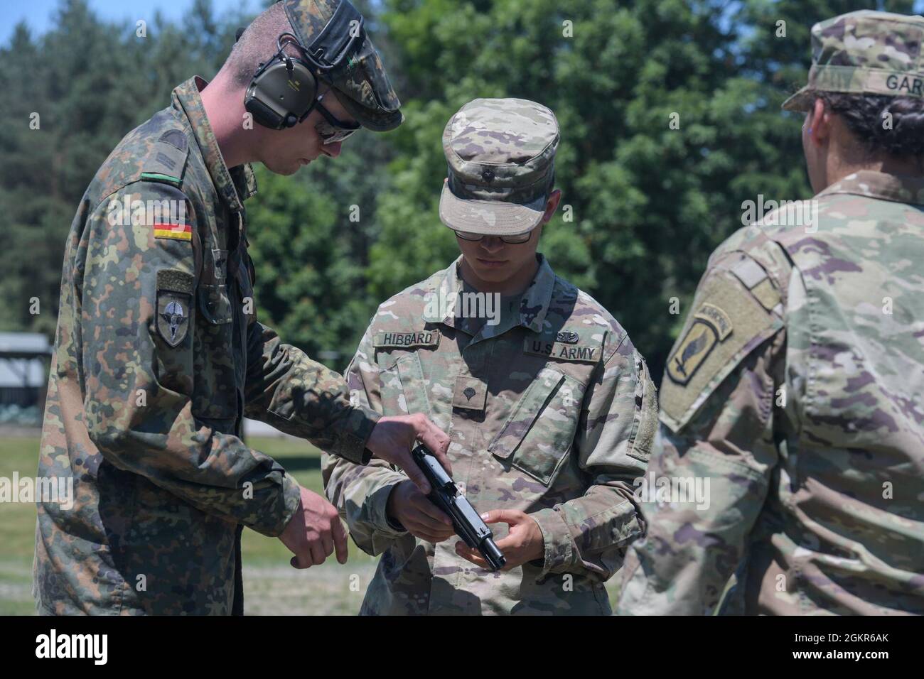 A German Army soldier, left, briefs U.S. Army paratroopers, assigned to ...