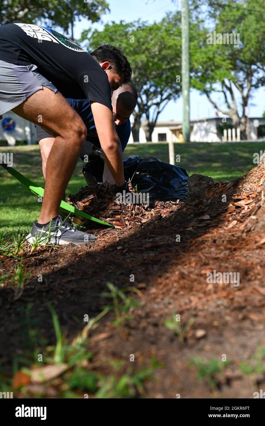 U.S. Air Force Airmen assigned to the 33rd Fighter Wing rake leaves ...