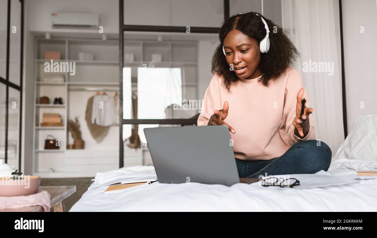 Black Freelancer Lady Making Video Call On Laptop In Bedroom Stock ...