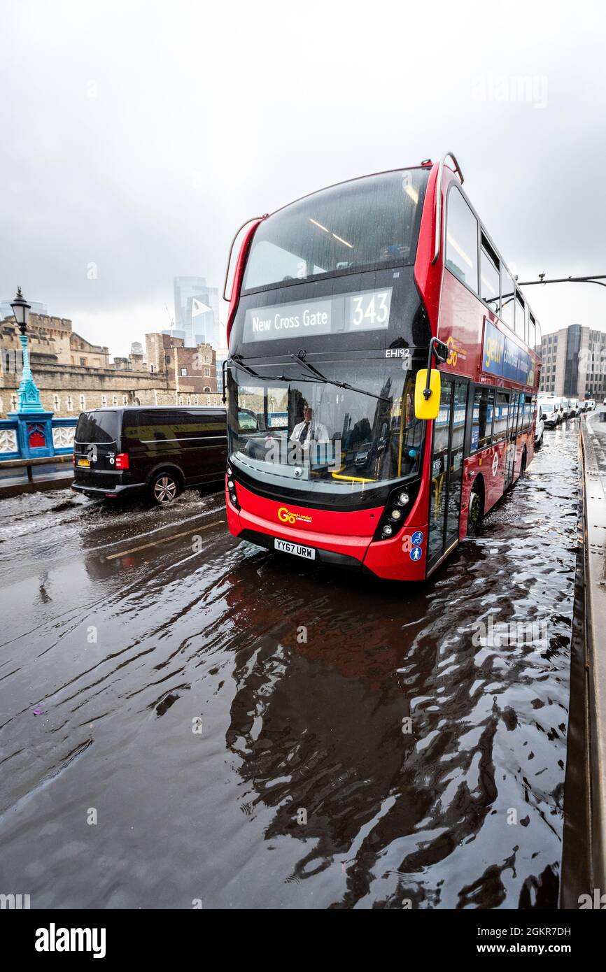 A bus navigates through the flooding on Tower Bridge Stock Photo - Alamy