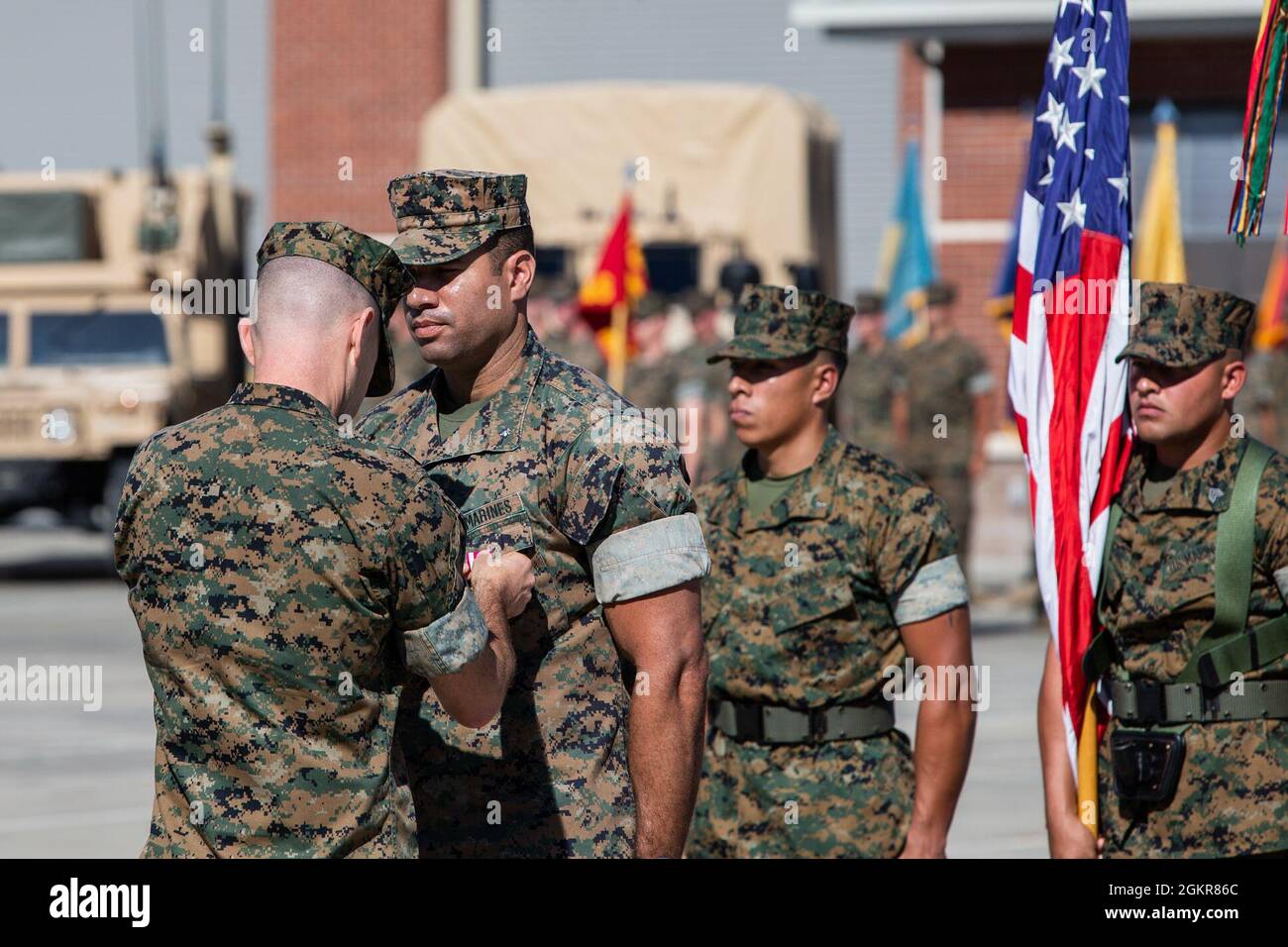 U.S. Marine Corps Lt. Col. Zachary A. Coates, center, receives the ...