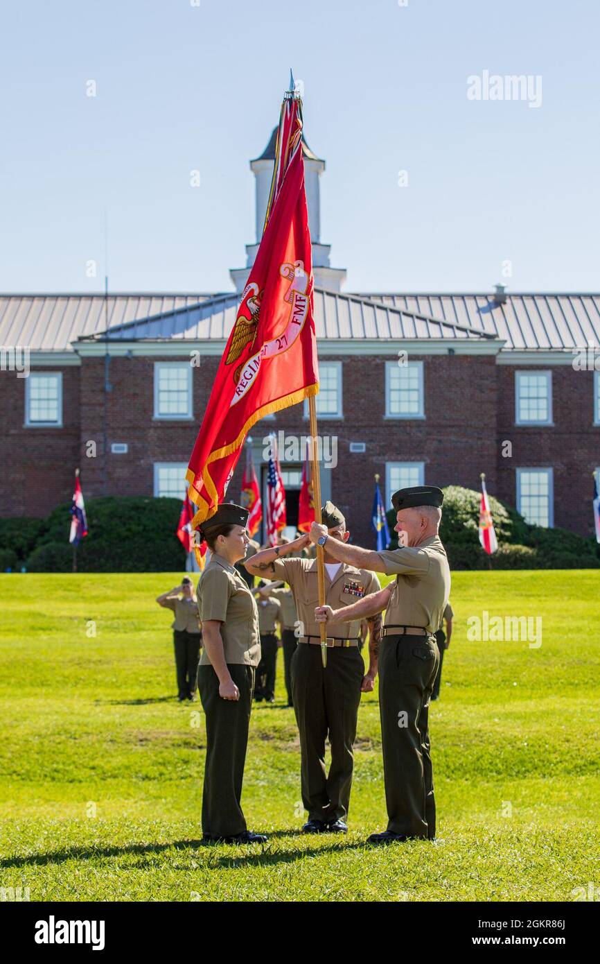 U.S. Marine Col. Brian W. Mullery, left, passes the regimental colors ...