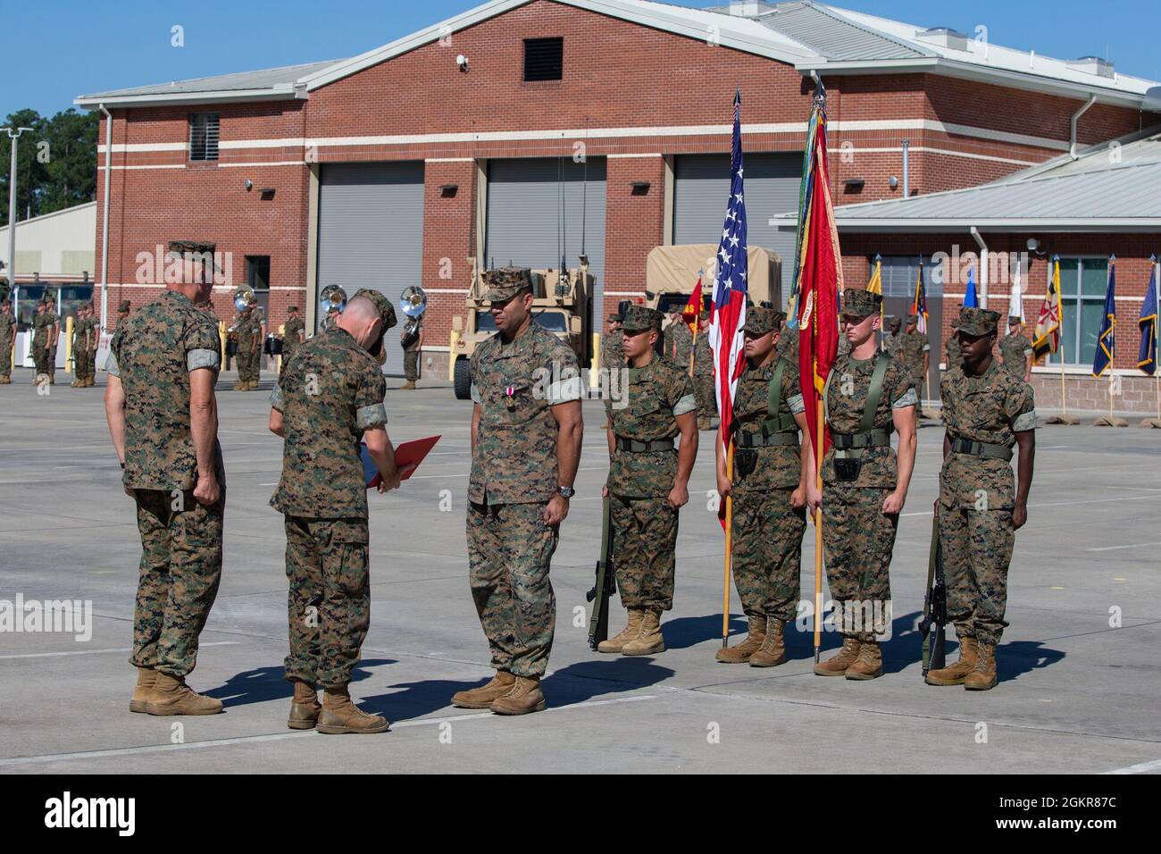 U.S. Marine Corps Lt. Col. Zachary A. Coates, center, receives the ...